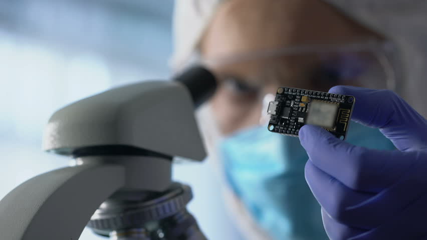 Technician Examining Chip, Using Microscope Stock Footage Video (100% ...