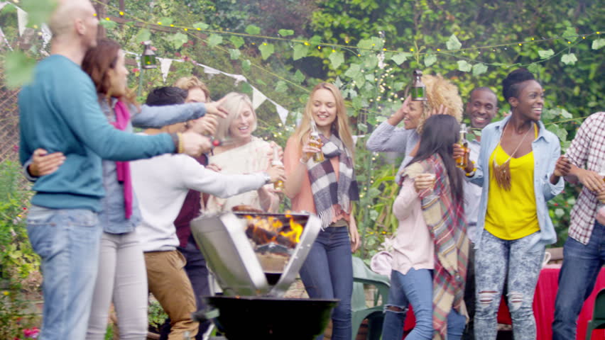 Young Adult Friends Serving Grilled Meat And Vegetables At Backyard ...