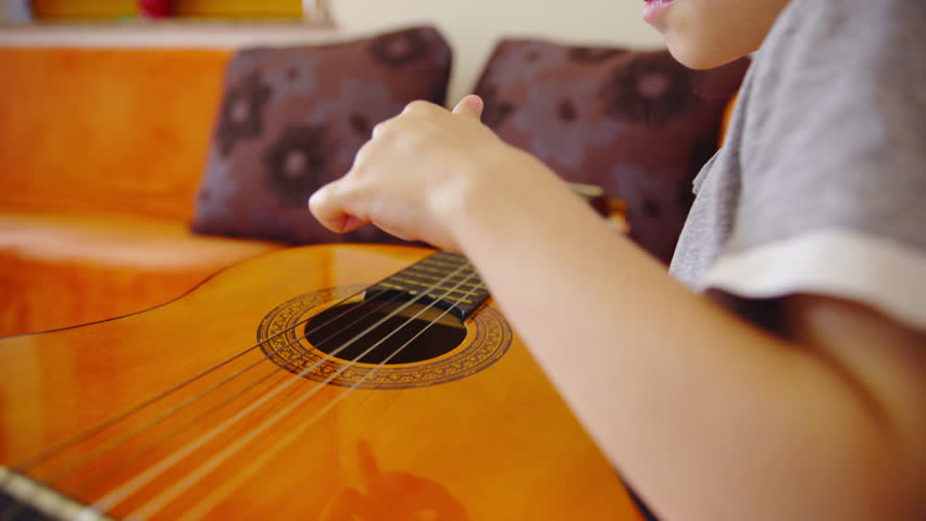Child Fingering Strings On Guitar Stockvideos & Filmmaterial (100 % ...