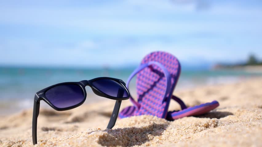 Flip-Flops And Sunglasses On Beach Against Sea. Closeup. HD, 1920x1080 ...