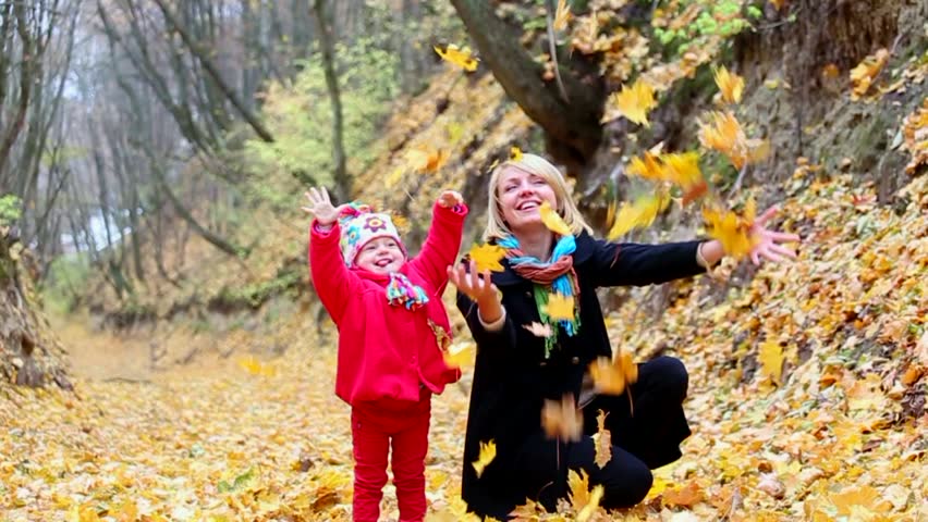 Stock video of mom and child playing autumn leaves | 12697358 ...