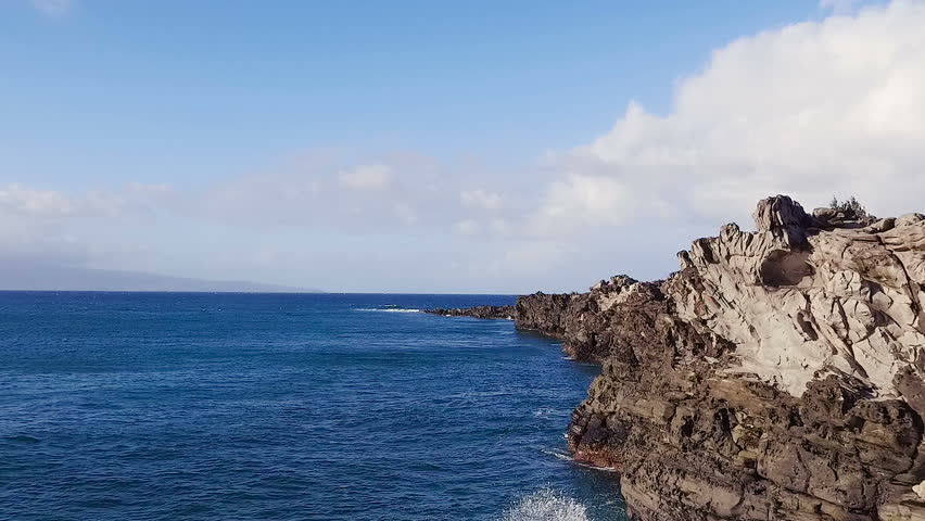Aerial View Of Cliff Jumping Into Ocean. Young Couple Jumps Off Cliff ...
