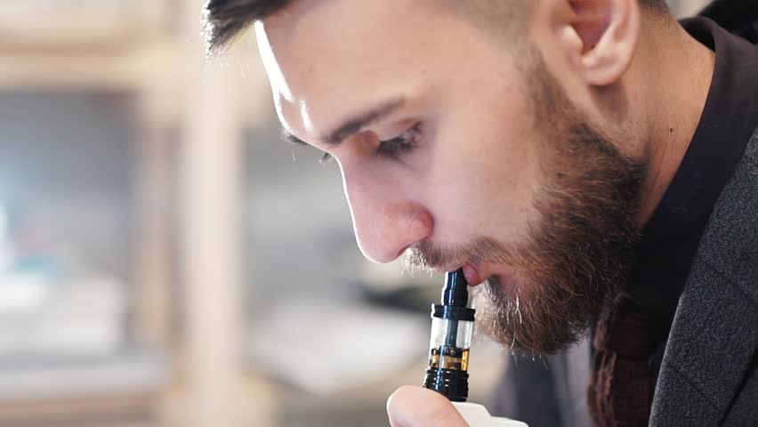 Stock Video Clip of Man Exhaling smoke from a vaporizer shot | Shutterstock
