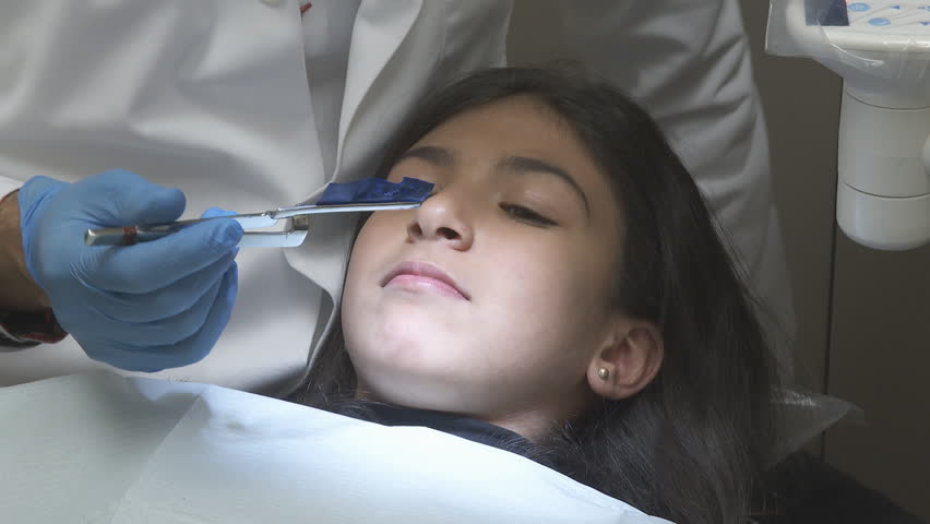 Dentist Bite Test On Young Girl - A Dentist Performs A Bite Wing Test ...