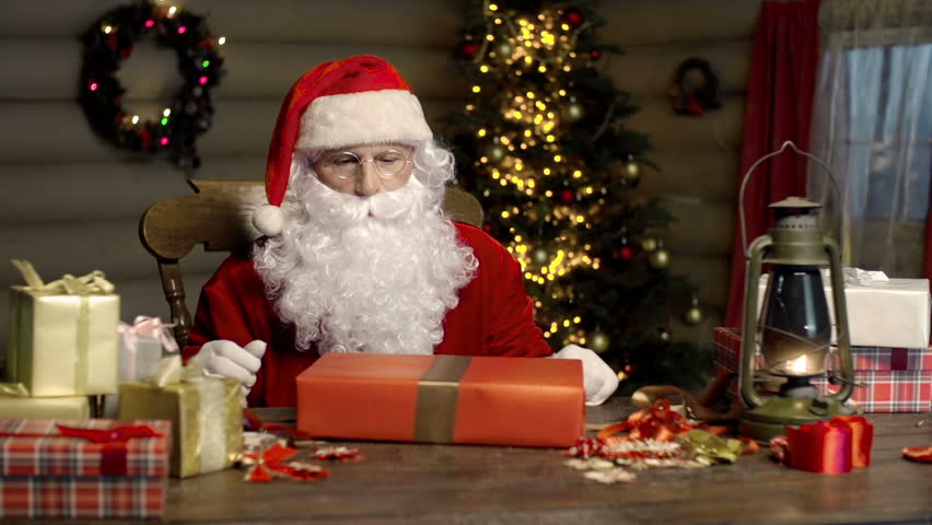 Santa Claus Packing Gift Boxes In Sack And Waving Hand Stock Footage ...