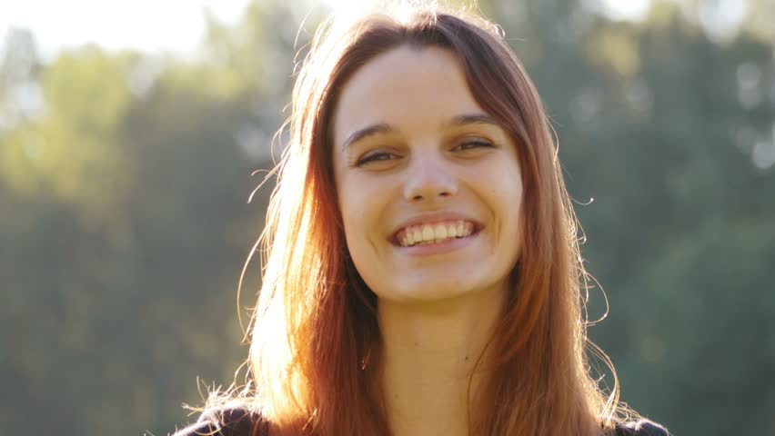 Young Pretty Girl Smiles Happily Into Camera Close Up Slow Motion