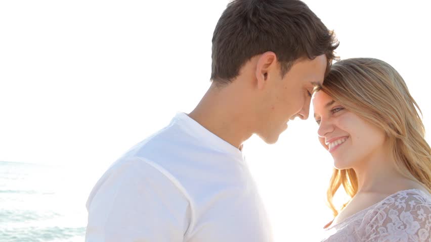 Side Portrait Of A Young Lovers Couple Embracing And Kissing On Lips On ...