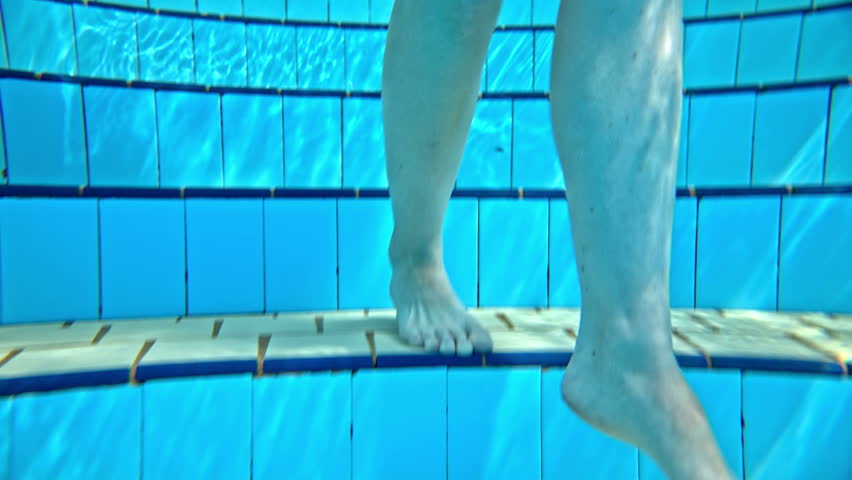 Person Walk In To Pool Close Up. Underwater View Of Person Legs Walking ...