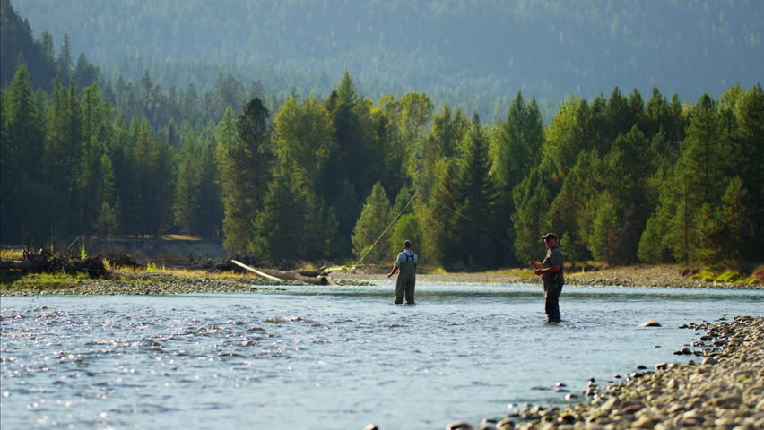 KENAI RIVER, AK CIRCA 2012: Anglers In Waders Stand In Rushing Glacial ...