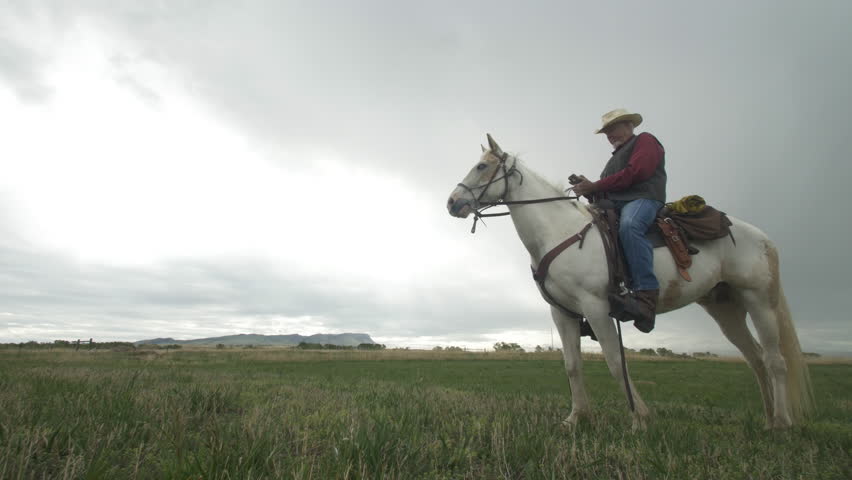 Old Cowboy On Horse Makes Phone Call - Low Angle Wide Dolly Left. Horse ...