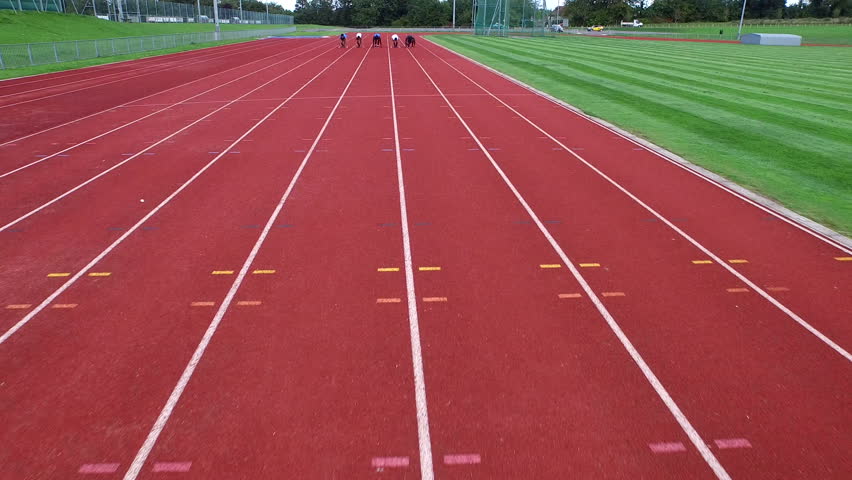 4K Drone Footage Of Track Athletes Crossing Finish Line At Running ...