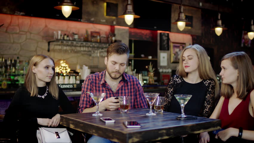 Happy Young People Sitting In The Bar Reading Menu Card And Giving ...