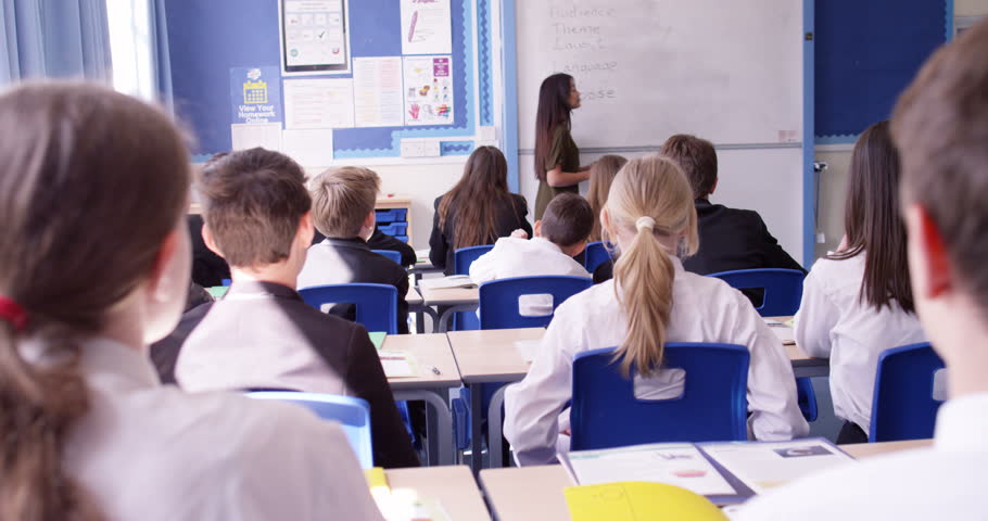4k, Group Of School Kids Sitting And Listening To Teacher In Classroom ...