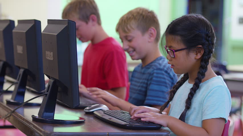Elementary School Student And Teacher Look At Computer วิดีโอสต็อก ...