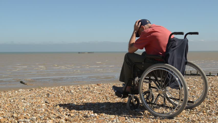 Lonely Disabled Woman Sits And Thinks In Her Wheelchair At The Water's ...