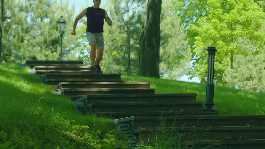Man Running Down Stairs. Fitness Man Running Downstairs In Park. Man ...