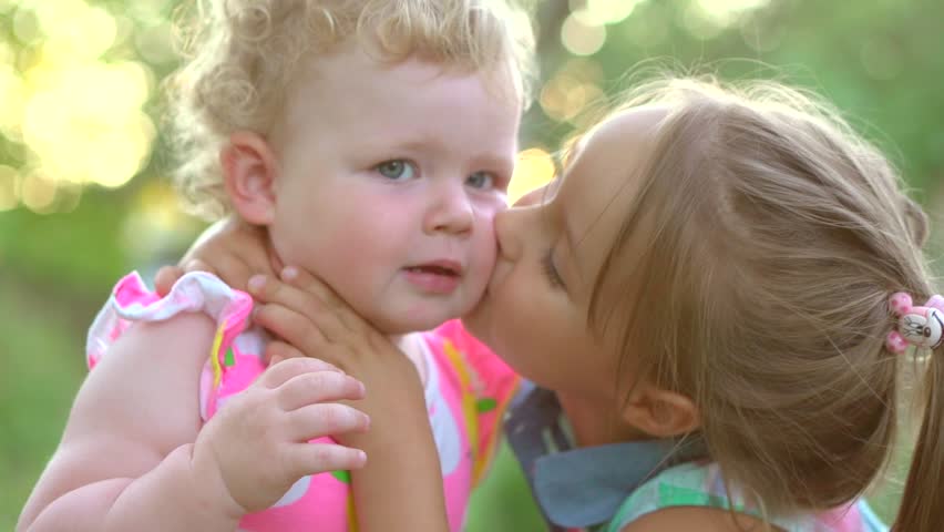 Two Kids On A Lawn, Having Fun, Smiling And Kissing Stock Footage Video ...