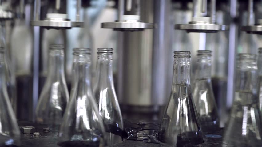 Spill Of Alcohol In Glass Bottles At The Plant. Conveyor Belt With ...