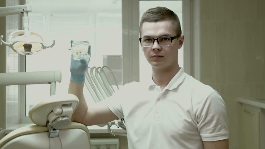 Young Blond Dentist Using His Cellphone At The Office. Handsome ...