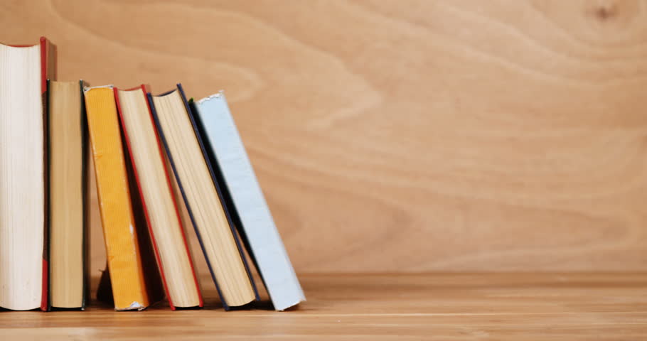 A Row Of Books Stacked Up On A Shelf. Stock Footage Video 1990027 ...