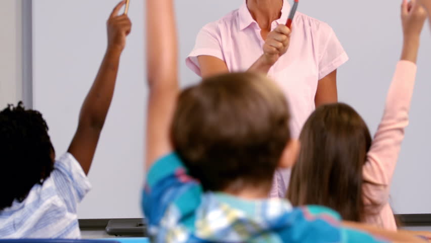 Stock Video Clip of Kids raising their hands while teacher teaching ...