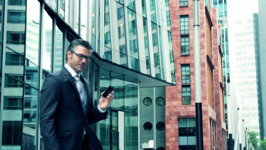 Stock Video Clip of Business man leaving office and answering phone ...