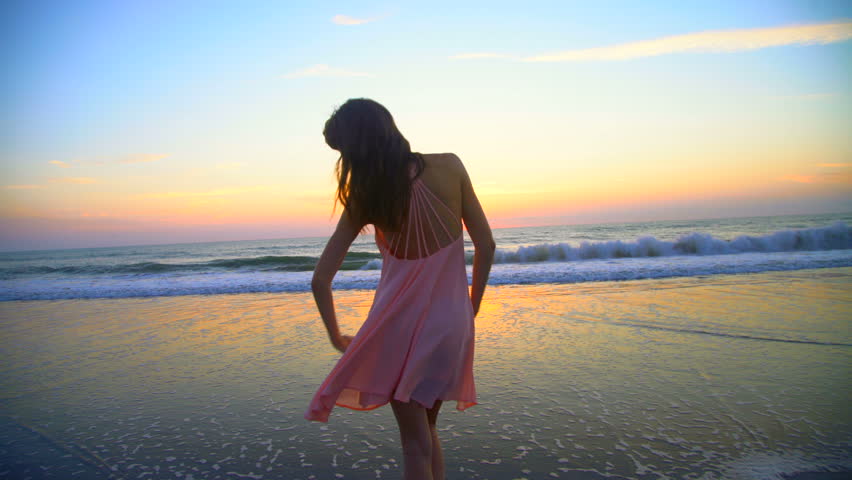 Woman Looking At Sea Sunset. Back View Of Woman Standing On Beach At ...