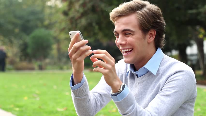 Attractive Young Student Is Happy Using Mobile Phone Sending Text ...