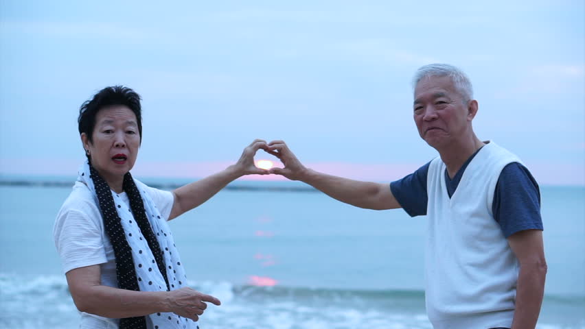 Attractive Senior Couple Dancing On The Beach And Confidently Enjoying A