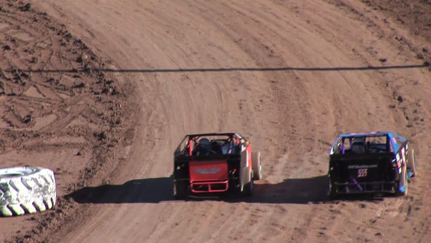 Aerial View Of Race Cars Rounding A Corner On A Dirt Track Stock ...