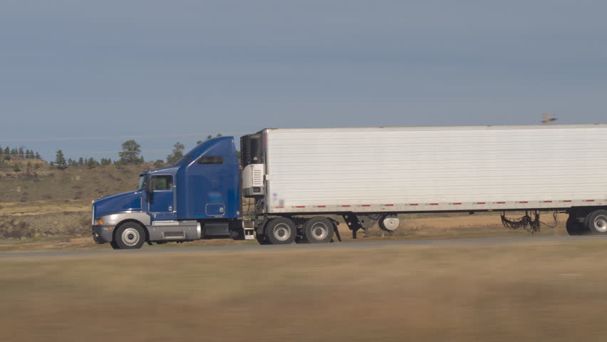AERIAL, CLOSE UP: Container Semi Truck Transporting Goods Driving On ...
