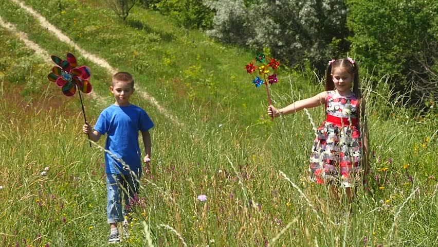 Children Are Played With A Wind Turbine. Children Colorful Pinwheel ...