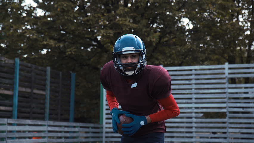 Slow Motion Of American Football Player Practising Throwing Ball During ...