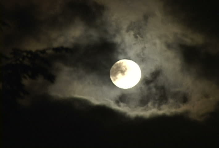 Full Moon Shining Bright Behind Clouds At Dark Night. Time Lapse Stock ...