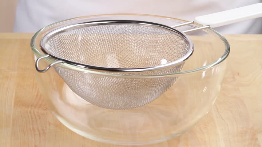 Stock video of flour being sieved into a bowl | 4232338 | Shutterstock