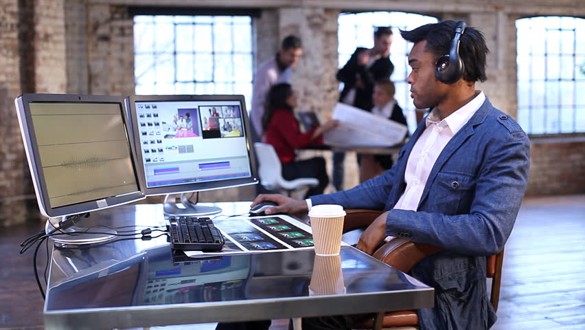 Creative Media Editor At Work. Small Team Gathering In Background To ...