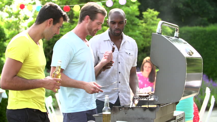 Young Adult Friends Serving Grilled Meat And Vegetables At Backyard ...