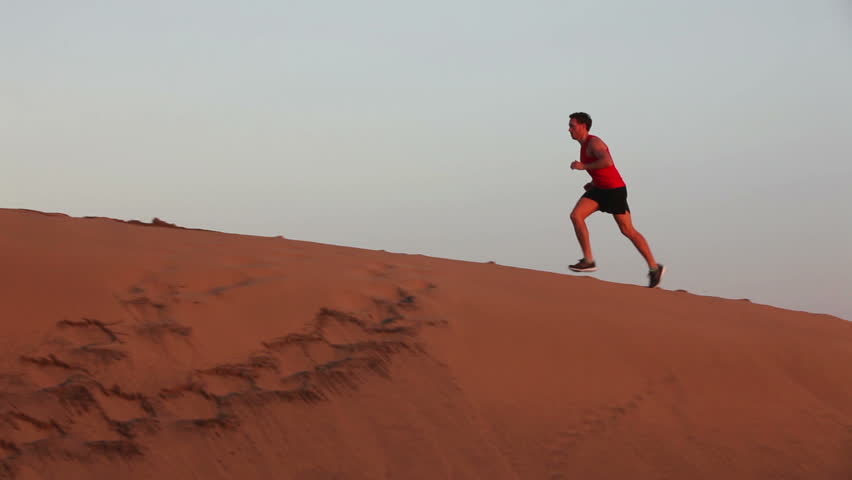 Runner Man Running Up A Hill Sand Dune In Desert. Fit Athletic Male ...