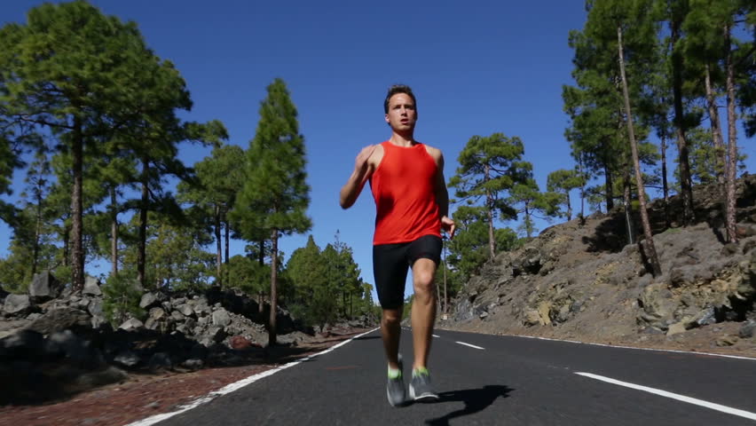 Running Man. Male Runner Training With Determination Outdoors On Road ...