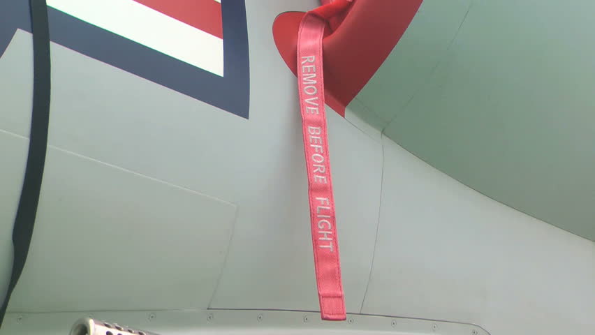 Stock video of a red remove before flight ribbon | 6728218 | Shutterstock