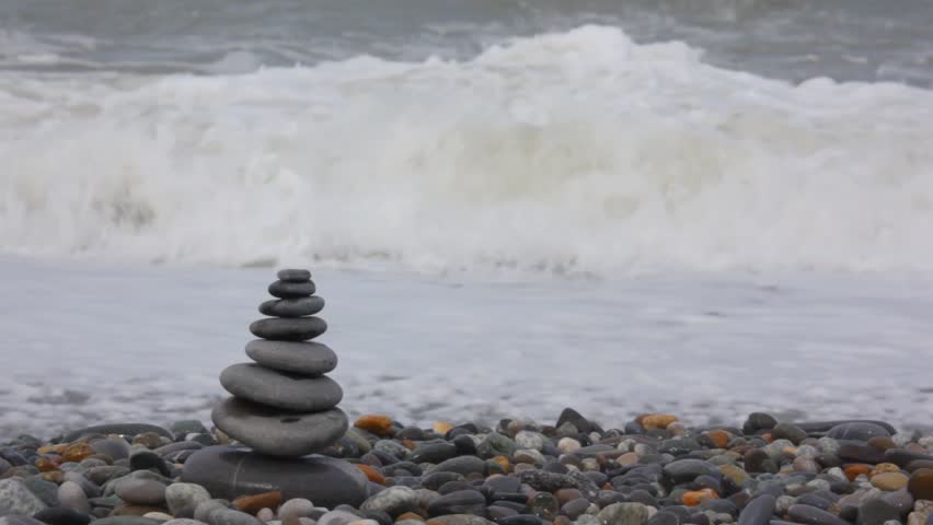 Pebble Stack On The Stone Seashore, Sea In Background Stock Footage ...