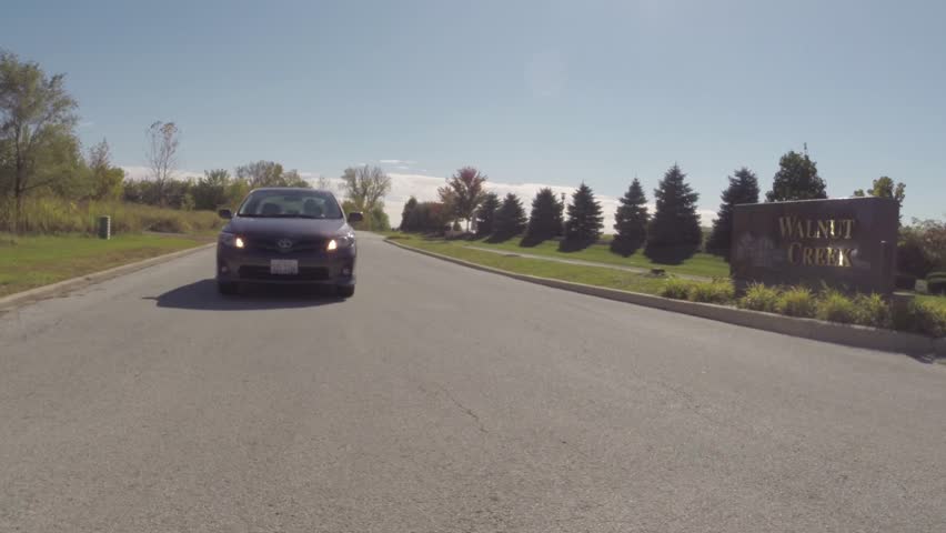 A Car Ride Down Road In Residential Suburban Neighborhood Looking At ...