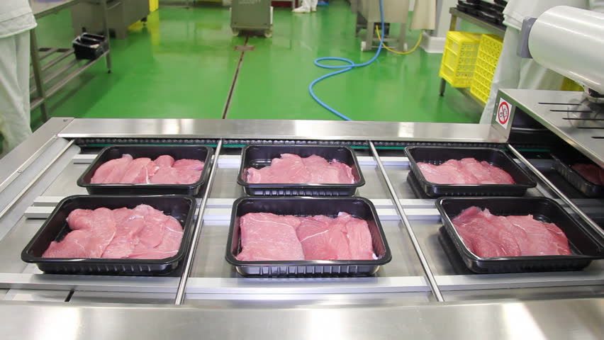 Employee Works At Meat Packaging Line. Raw Fresh Meat In Vacuum And Gas ...