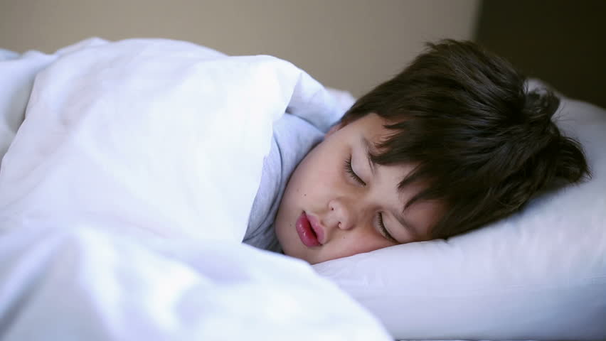 Stock Video Clip of little boy sleeping restlessly | Shutterstock