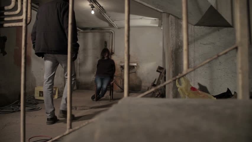 Female Hostage With Bag On Head Sitting Tied In Dirty Dark Basement ...