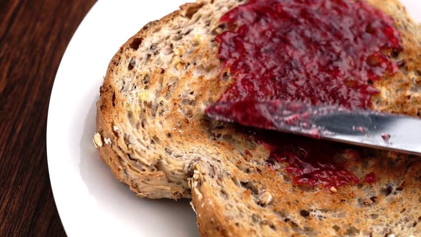 Stock video of strawberry raspberry jam being spread on | 8833678 ...